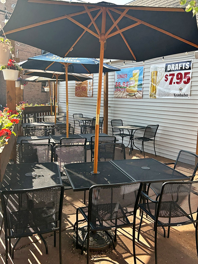 The outdoor patio – where summer evenings transform pizza night into an al fresco celebration under market umbrellas.