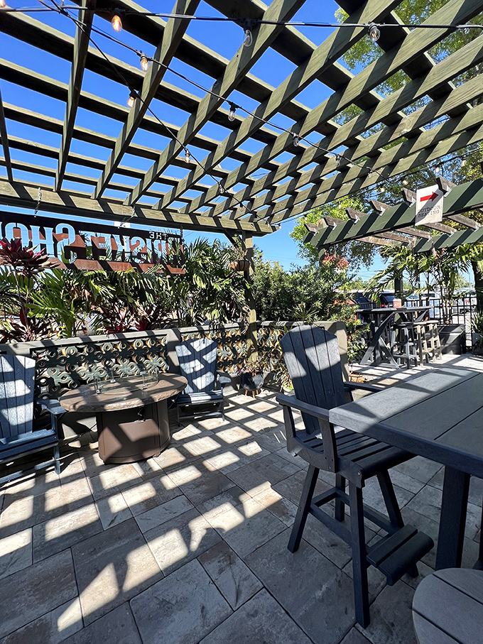 The pergola-covered patio isn't just outdoor seating—it's where you'll want to spend every Florida evening, with dappled sunlight and smoky aromas.