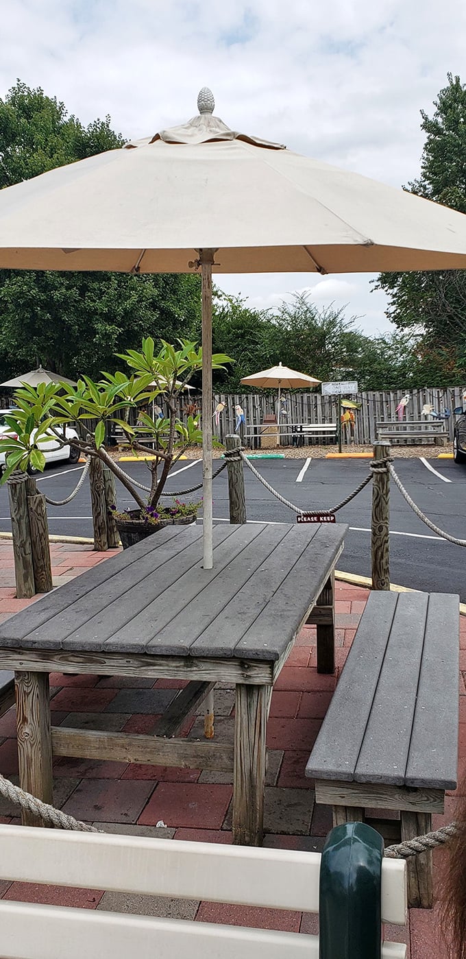 Rustic outdoor seating under beach umbrellas – where burger bliss meets fresh air in perfect harmony.