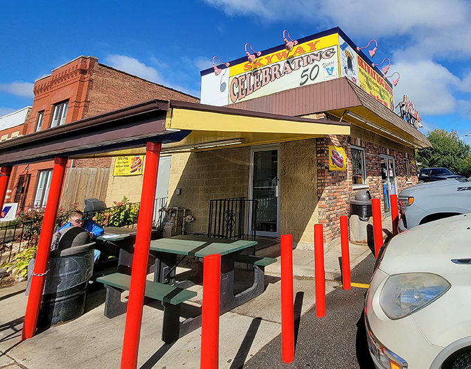 The outdoor seating area—simple picnic tables where strangers become neighbors over the shared language of great food.