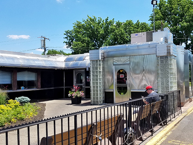The outdoor waiting area where anticipation builds—like the line outside a rock concert, except the star is a perfectly grilled cheese sandwich.