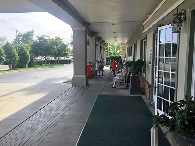 The covered porch offers a moment of pause—a transitional space between Florida sunshine and the comfort food paradise waiting inside.