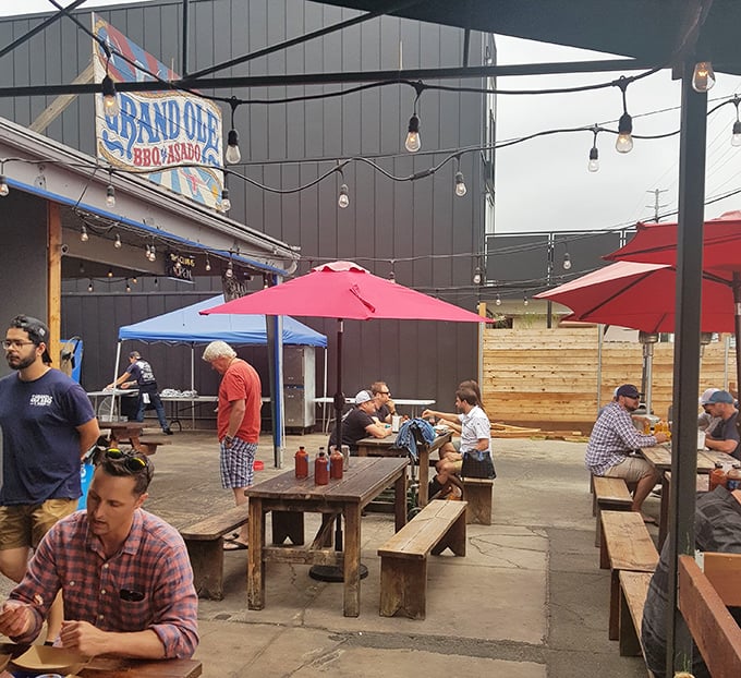 Picnic tables under string lights—the universal signal that good times and better food are just moments away.