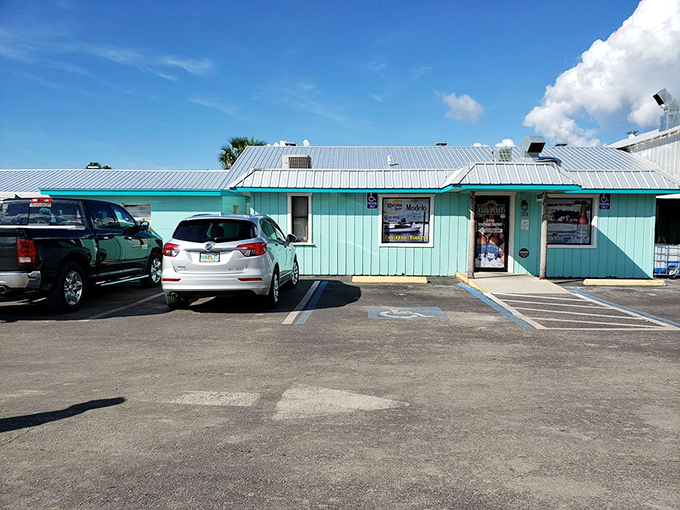 The humble parking lot of The Crab Plant—where vehicles of all types gather in democratic unity for the pursuit of exceptional seafood.