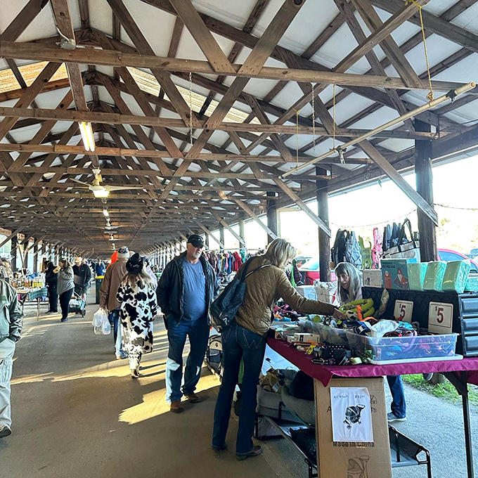 Bargain hunters in their natural habitat! The pavilion's wooden beams frame a perfect Saturday morning of discovery and unexpected finds.