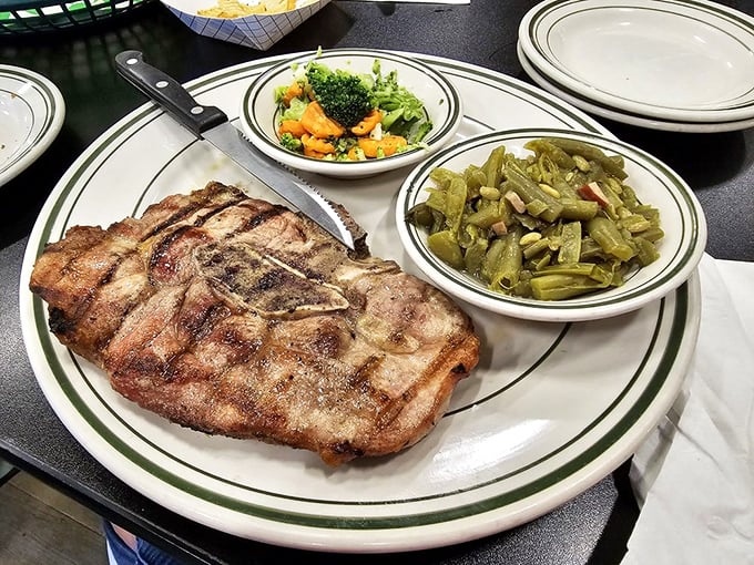 A pork chop with perfect grill marks flanked by green beans and a salad – proof that Tom & Ray's isn't just about breakfast.