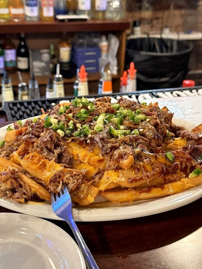 Loaded fries that make French cuisine look underdressed—pulled pork and green onions creating a fork-fighting masterpiece.