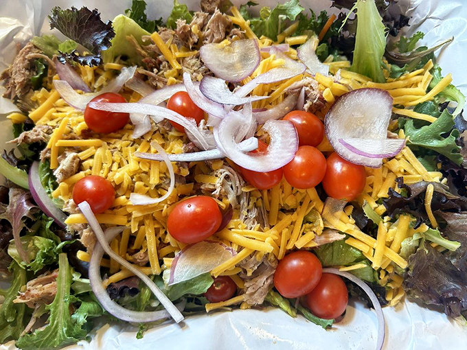 Barbecue goes light(ish)—pulled pork atop fresh greens with cheese and veggies. The salad that meat-lovers order without feeling like they're compromising.