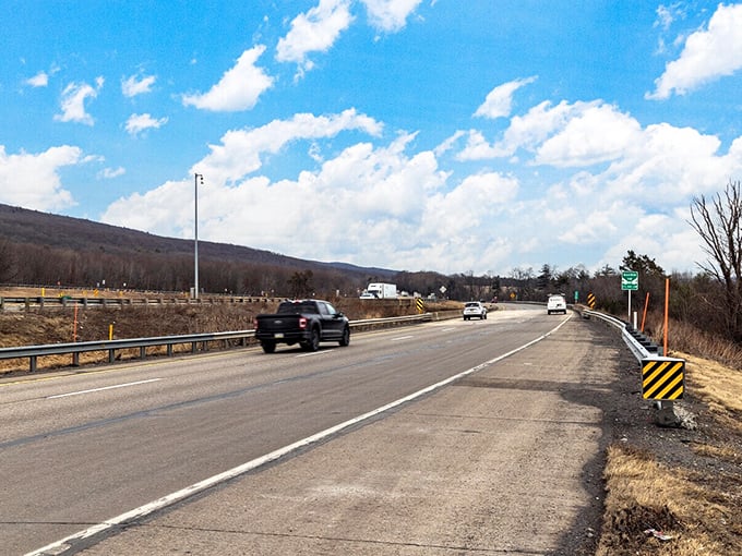 The open road stretches toward rolling hills, a reminder that sometimes the journey itself is the destination worth savoring.