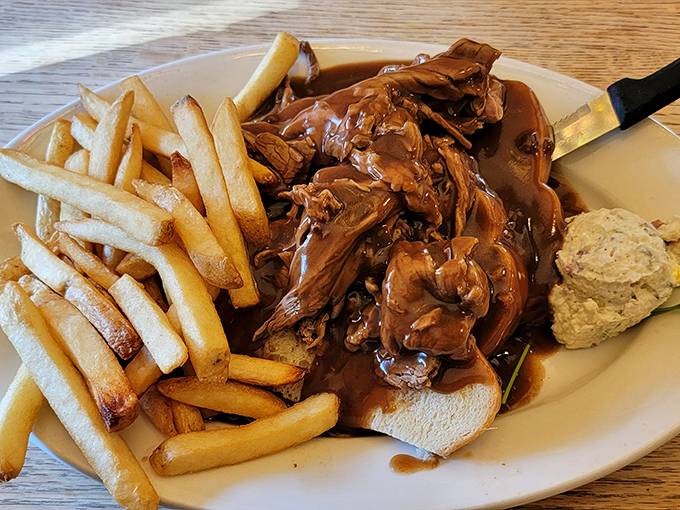 This hot roast beef sandwich isn't just lunch – it's therapy on a plate, complete with gravy generous enough to make your cardiologist nervous.