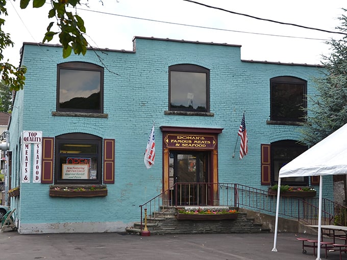 Roman's Famous Meats & Seafood's turquoise façade promises culinary treasures inside—the kind of place where recipes are guarded like family heirlooms.