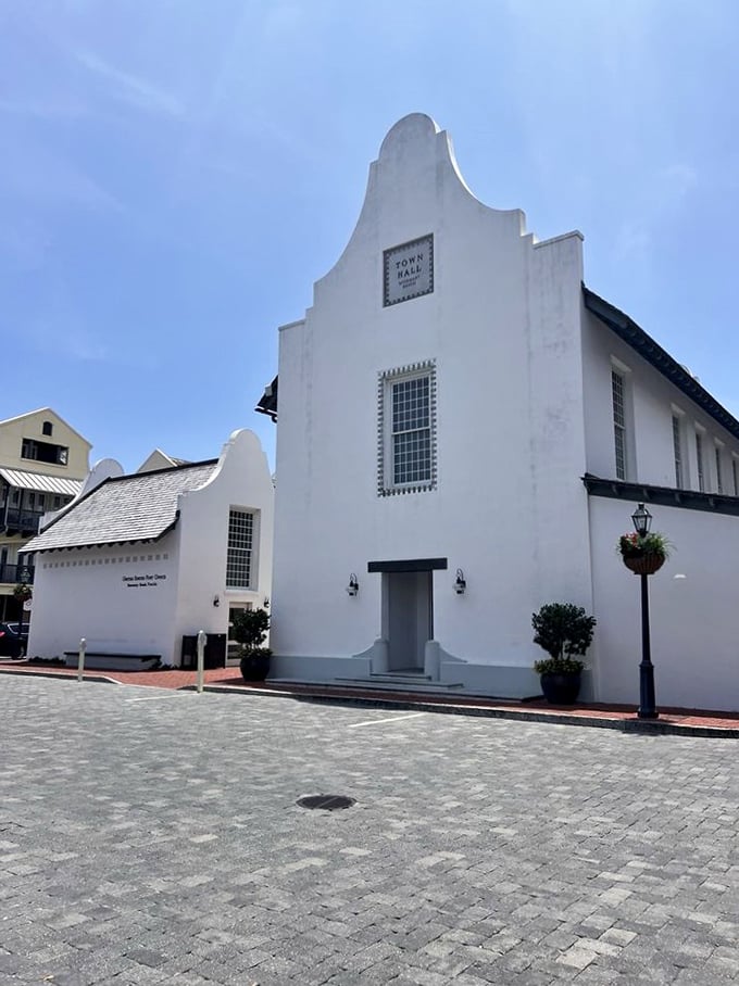 The Town Hall's distinctive Dutch-inspired architecture stands as a community anchor, its clean white façade gleaming against Florida's blue skies.