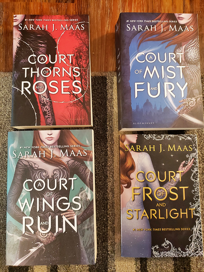 Sarah J. Maas' beloved fantasy series waits for the next reader to fall under its spell – these dog-eared copies have already transported countless minds to magical realms.