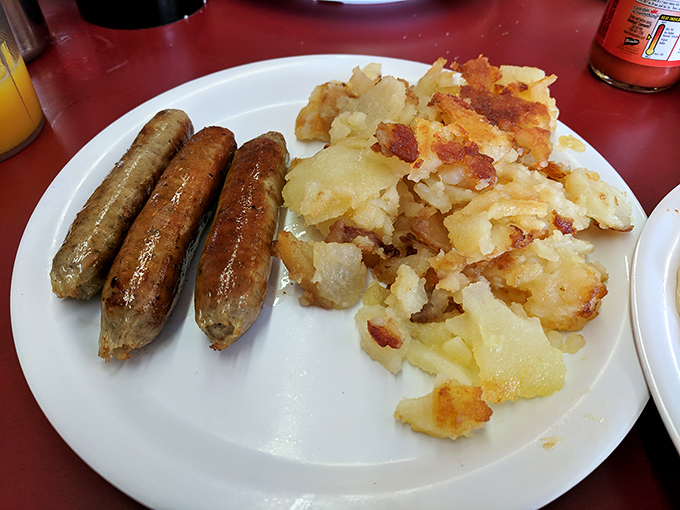 Breakfast sausages with that perfect snap and home fries that somehow contain both crunch and fluff—simple food done extraordinarily well.