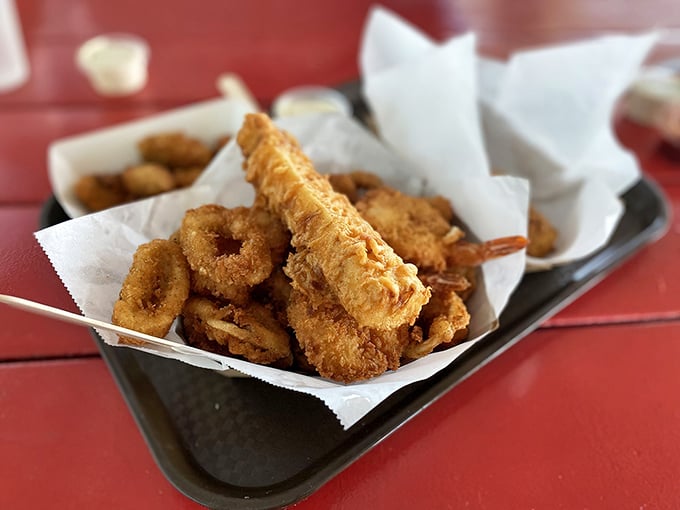 This generous seafood combo with onion rings proves that variety truly is the spice of life.