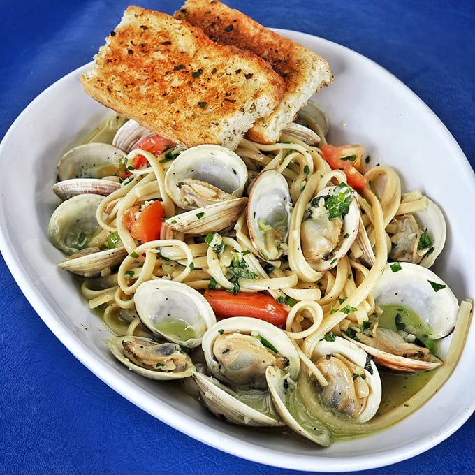 Linguini and clams—where Italy and New England have a delicious love child. That garlic bread isn't a side; it's essential equipment for sauce-sopping.