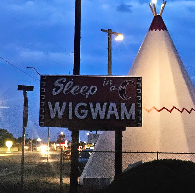 The iconic "Sleep in a Wigwam" sign promises exactly what it delivers with delightful directness.