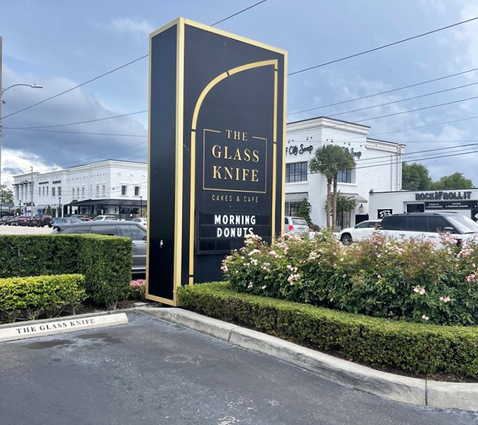 The elegant roadside sign stands tall like a beacon of hope for sugar-seekers—a sophisticated landmark announcing "salvation from ordinary desserts lies within."