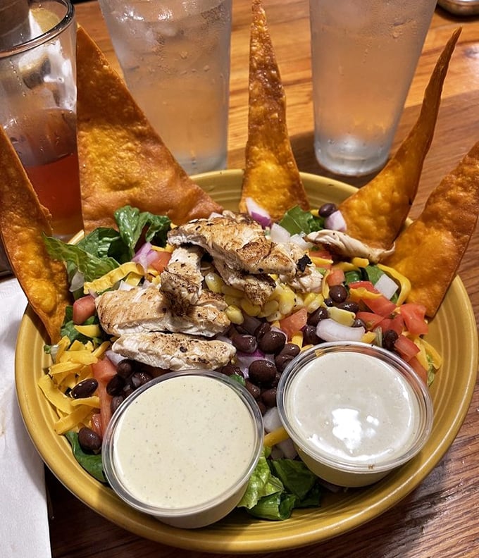 A salad that doesn't apologize for being healthy—fresh ingredients arranged like edible art, with fried tortilla points standing guard around the perimeter.