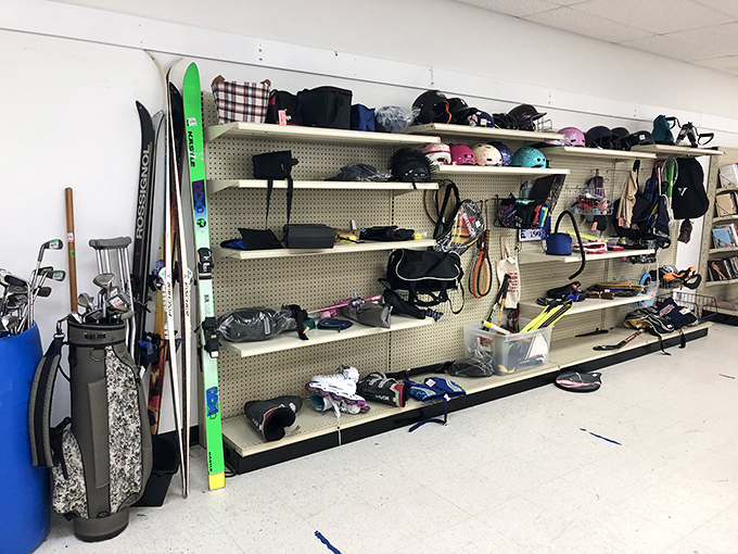 Seasonal sports equipment patiently waiting for its moment to shine. Those skis have stories of black diamond runs—or at least ambitious beginners.