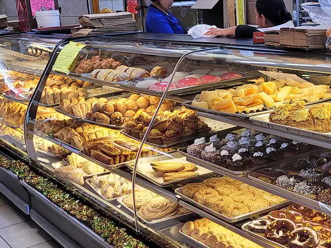 The display case doesn't just hold pastries—it contains dreams made of flour, sugar, and butter, each one promising a moment of pure, uncomplicated joy.