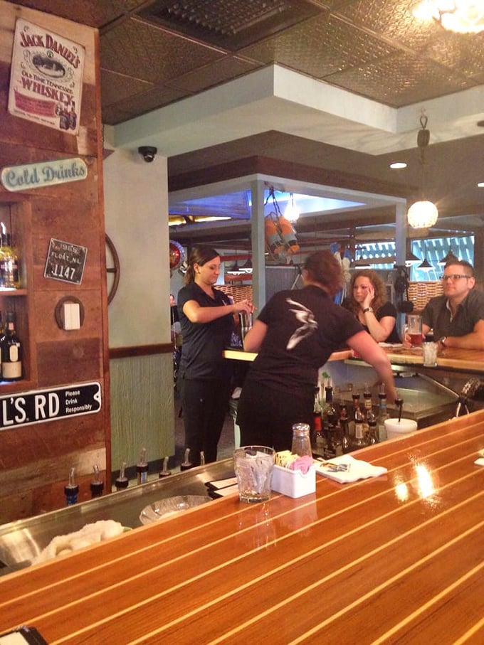 Where the magic happens—skilled bartenders crafting liquid happiness while patrons await their next culinary adventure.