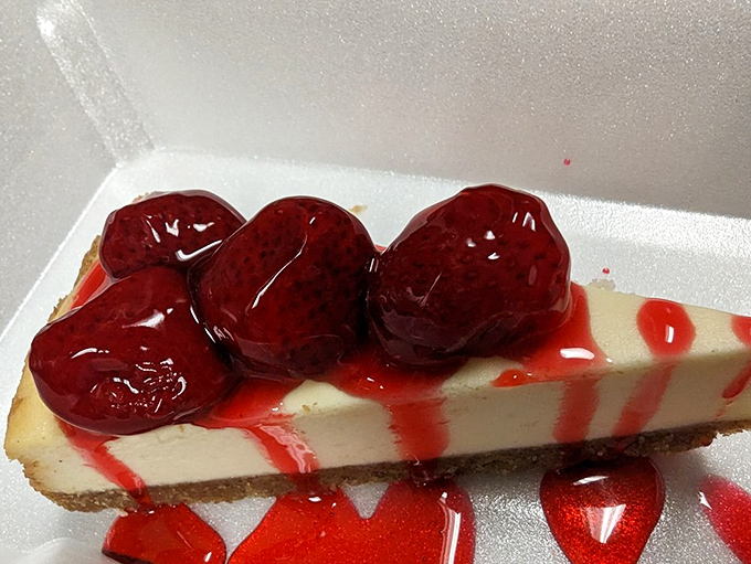 Cheesecake that doesn't need to be from New York to be spectacular. Those cherries aren't decoration—they're the crown jewels.