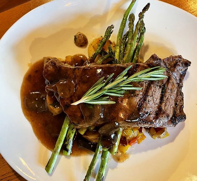 A steak that's dressed for success – tender beef in rich sauce with asparagus standing at attention, ready for your dining pleasure.
