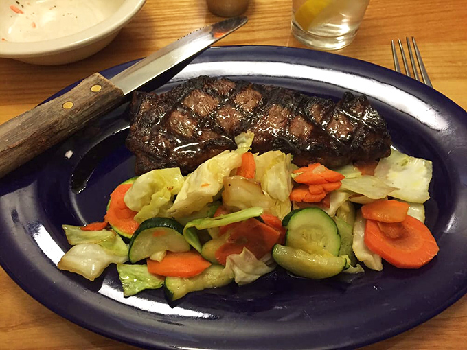 A perfectly seared steak shares the spotlight with a rainbow of vegetables—proof that simple food done right is culinary poetry.