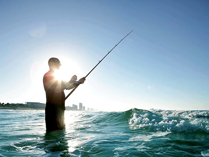 Surf fishing at dawn captures the essence of retirement freedom: standing in warm Gulf waters while waiting for dinner to bite.
