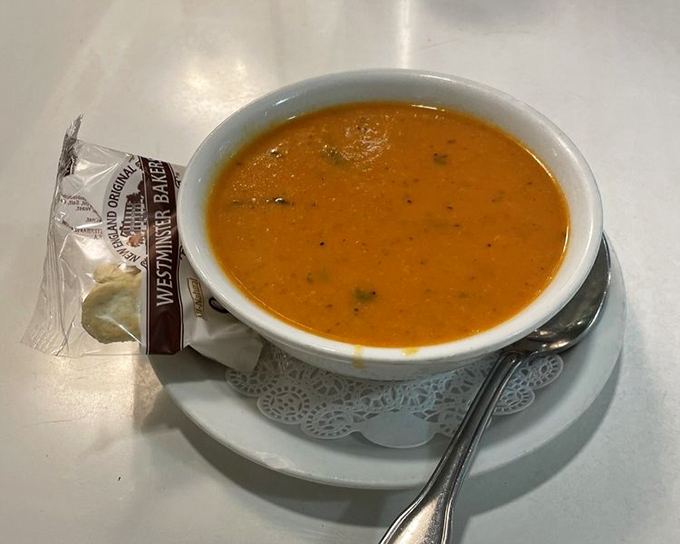 Tomato soup that doesn't come from a can, accompanied by its faithful cracker companion—comfort in a bowl that grandmother would approve.