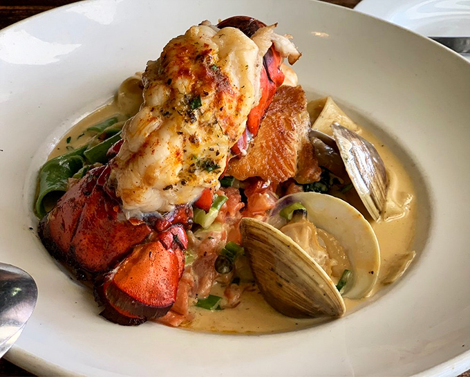 The ultimate seafood pasta featuring lobster tail and clams swimming in a broth so good you'll consider drinking it directly from the bowl.