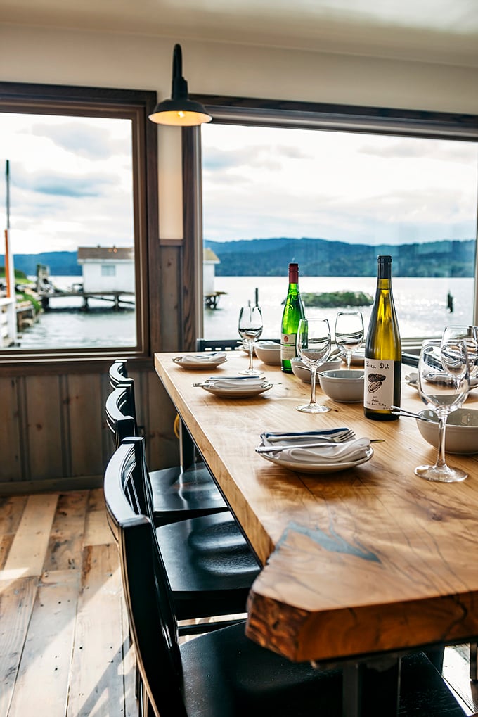 A table with a view that makes you wonder why we ever invented walls between dining rooms and million-dollar waterfront scenery.