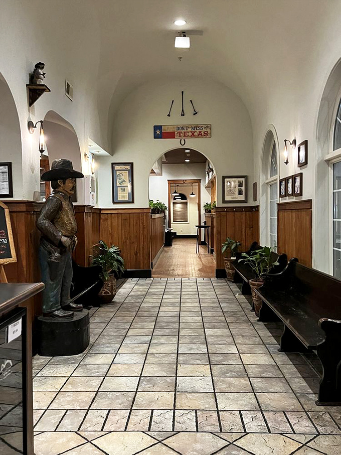 The entrance hallway feels like stepping into an old Texas mission, complete with cowboy statue standing guard over your dining experience.