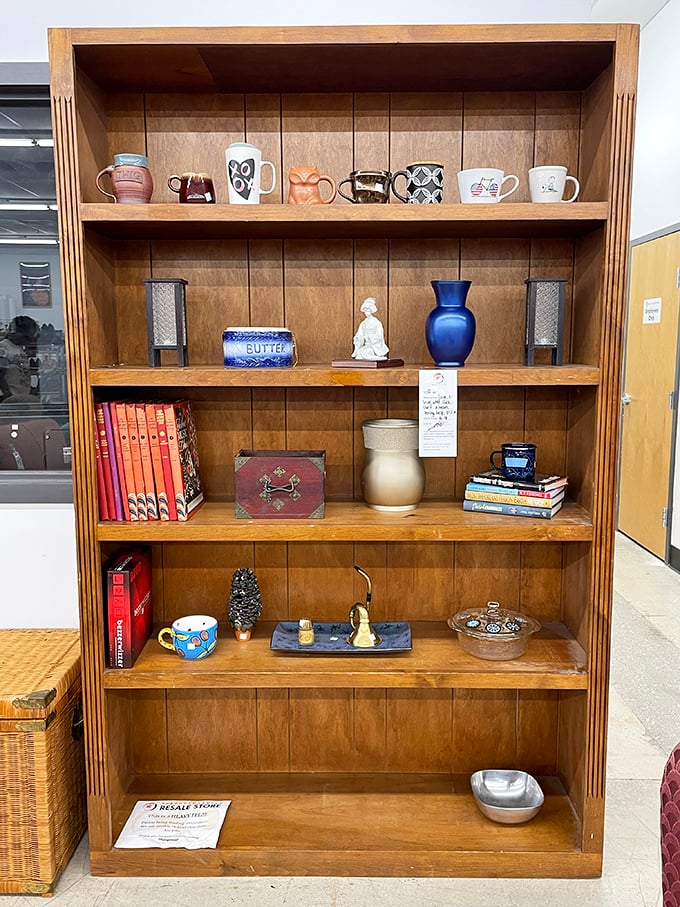 This wooden bookcase isn't just furniture—it's a curated collection of someone's former treasures waiting to become yours. Mugs with personality included!