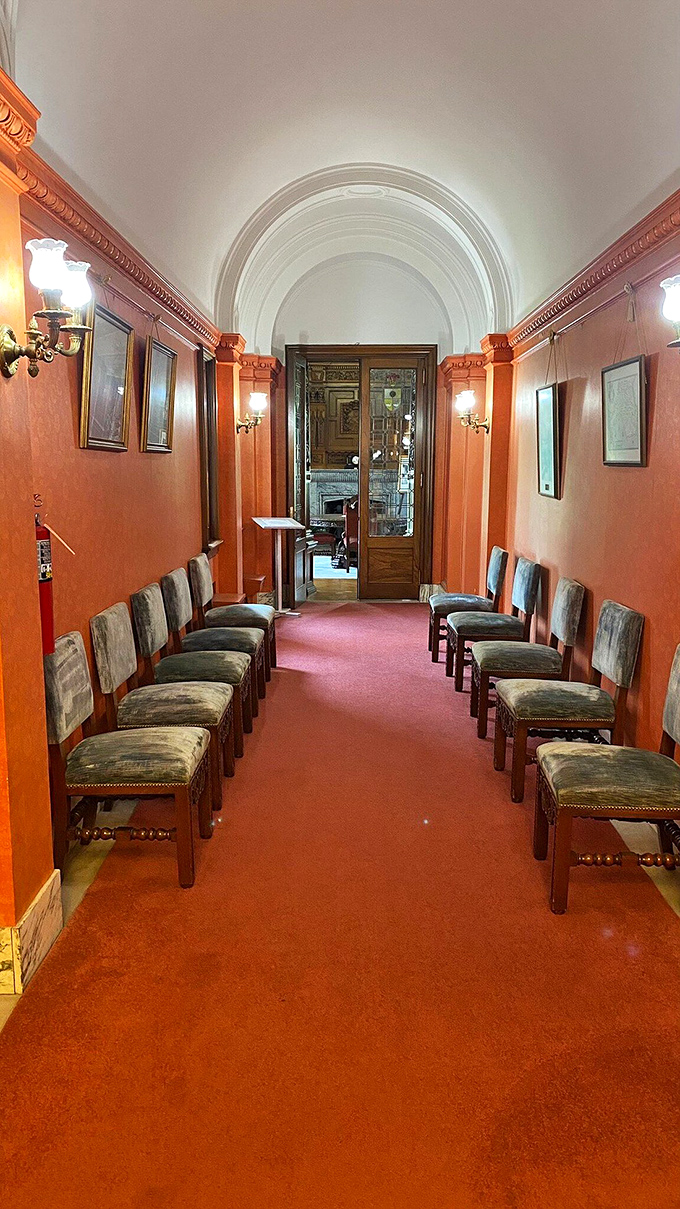 This coral-hued hallway with its barrel-vaulted ceiling feels like the backstage area of a particularly elegant theater from another era.