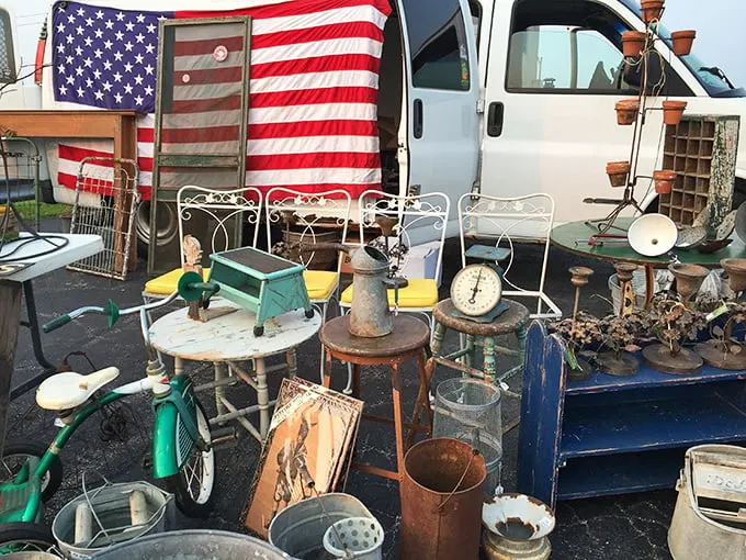 Americana on display—where rusty treasures, vintage scales, and weathered flags create a time capsule of nostalgic design.
