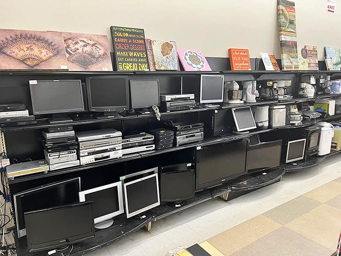The electronics graveyard – where yesterday's cutting-edge technology comes to find new purpose. That row of TVs has witnessed everything from "Friends" to "Game of Thrones."