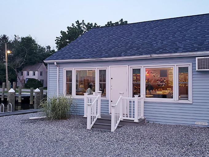 As evening approaches, the simple blue building glows with promise—like a beacon signaling to hungry travelers that authentic seafood awaits within.