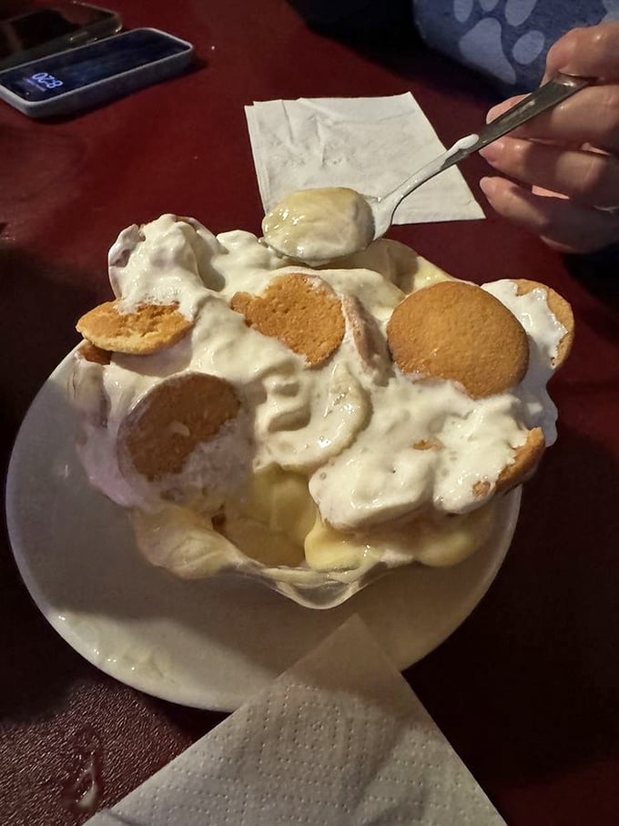 Banana pudding elevated to an art form—vanilla wafers standing like sentinels in a creamy sea of nostalgia that tastes like childhood memories.