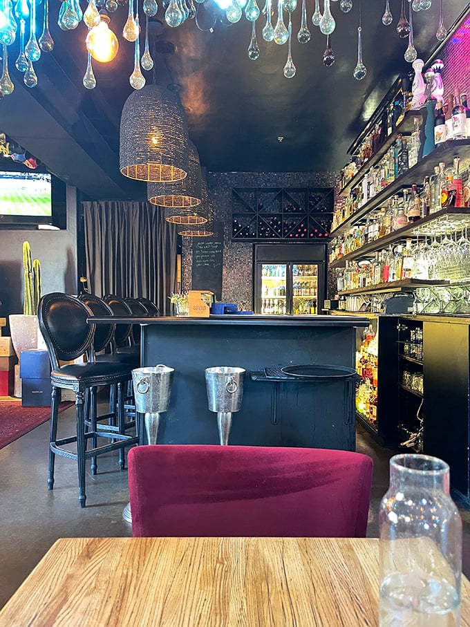 The bar at Elvira's isn't just stocked—it's a liquid library of tequila and mezcal, with pendant lights creating the perfect mood for exploration.