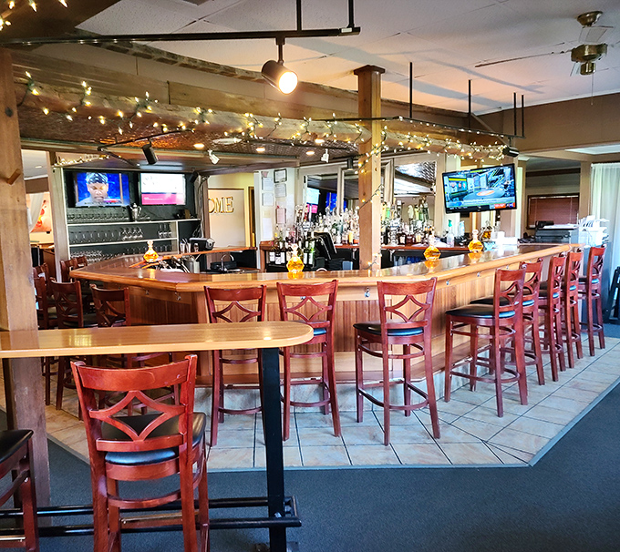 The bar area—where strangers become friends and friends become family over drinks that somehow taste better when served with a side of conversation.