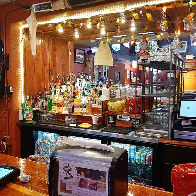 The bar area glows with the warm promise of cold drinks—where stories get better with each sip and strangers become friends.