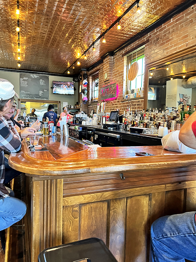 The bar area, where strangers become friends over shared appreciation of good drinks and the anticipation of great burgers.