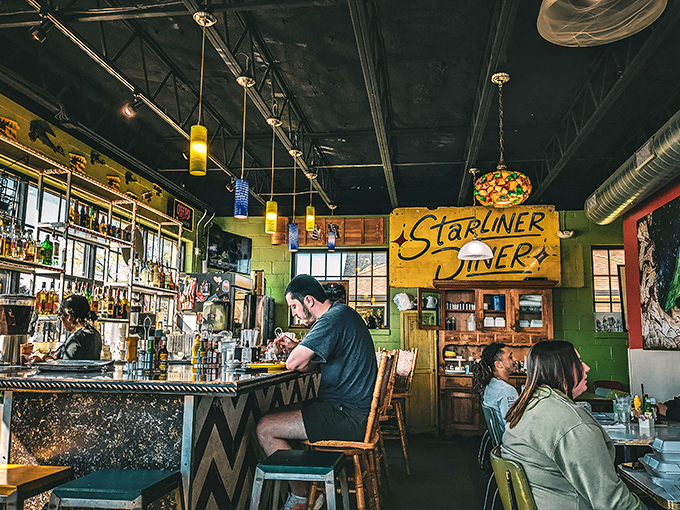 The bar area offers front-row seats to the culinary magic. Where strangers become friends over coffee mugs and shared food recommendations.