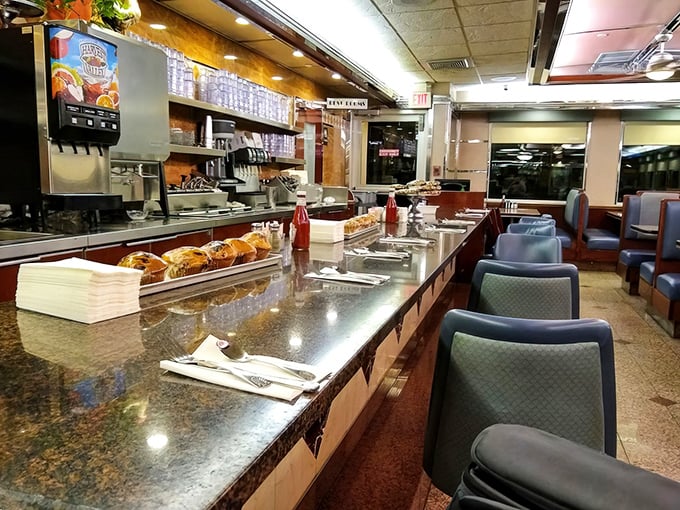 The counter offers front-row seats to the culinary action—where regulars perch on mint-green stools and staff members pour coffee with telepathic timing.