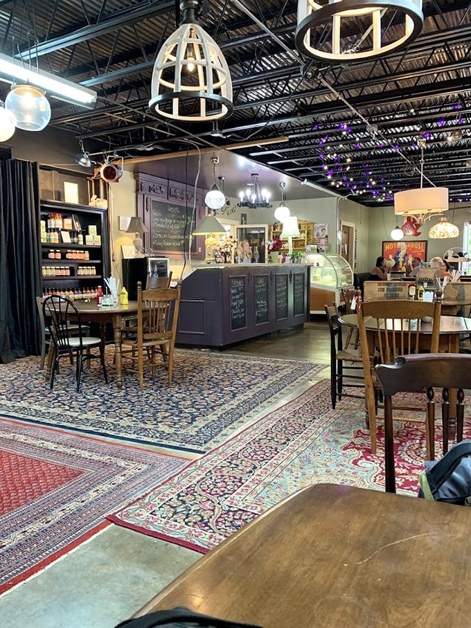 Not just a café, but a time-traveling dining experience. Those overlapping Persian rugs create islands of color beneath mismatched vintage chairs.