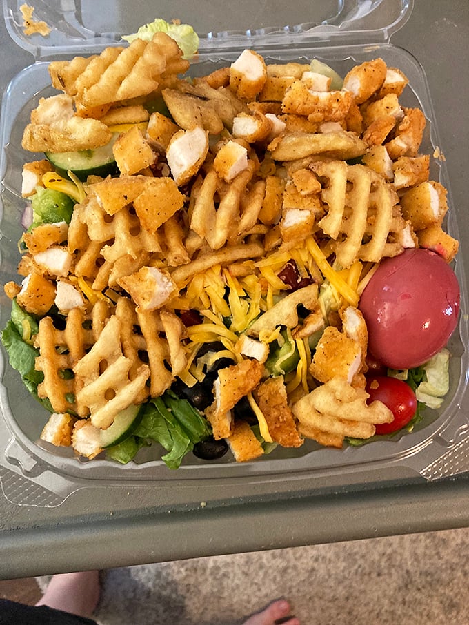 This isn't just a salad—it's a texture playground where crispy waffle fries, crunchy greens, and tender chicken create the perfect bite every time.