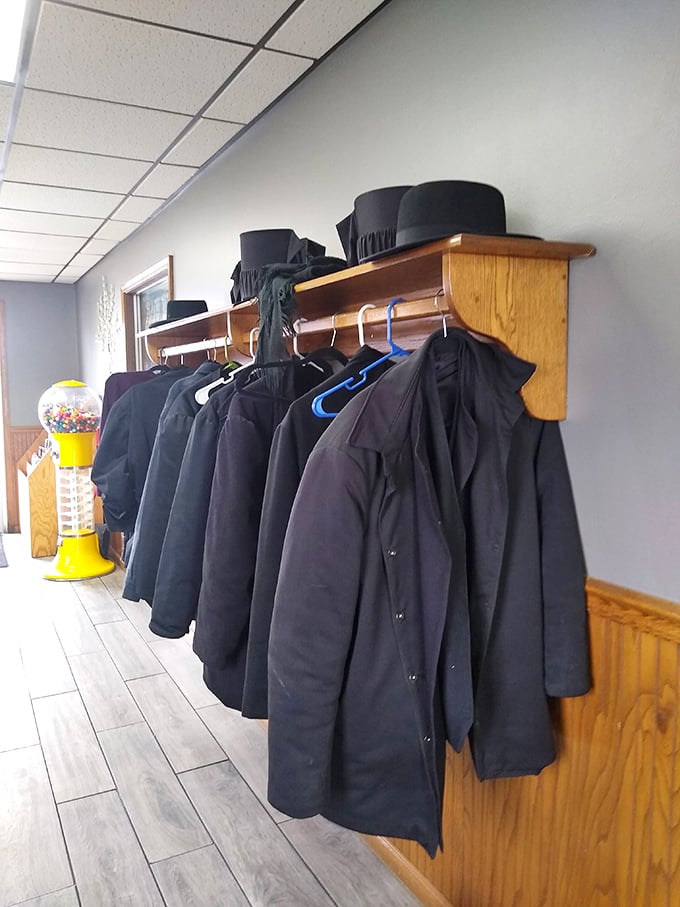 Not just coats hanging here but tradition itself—Amish hats and jackets waiting patiently while their owners enjoy hearty, homestyle meals.