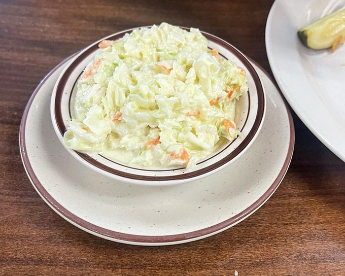 Coleslaw that knows its role—bright, crisp, and ready to cut through the richness of whatever main dish you've wisely ordered.